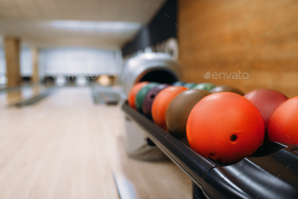 Color bowling balls in feeder, bowl game concept Stock Photo by NomadSoul1