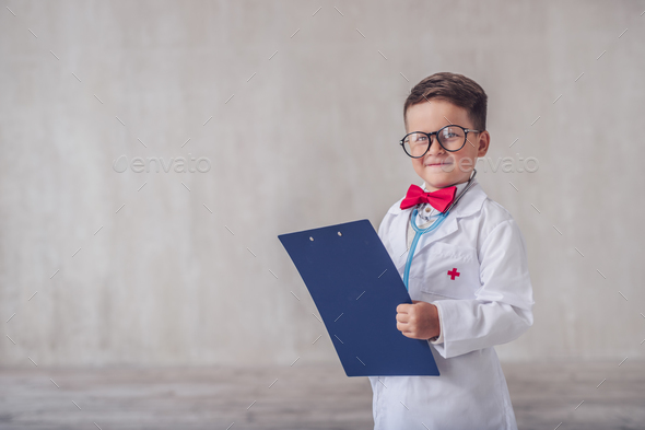 Smiling child with a clipboard Stock Photo by AboutImages | PhotoDune