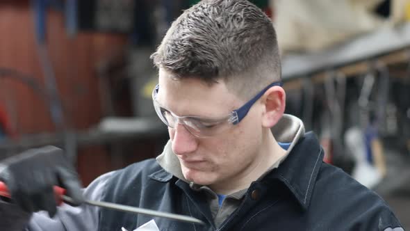 Craftsman filing metal in workshop, Stock Footage | VideoHive