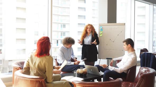 Female Business Consultant Reading a Lecture for Group of Young ...