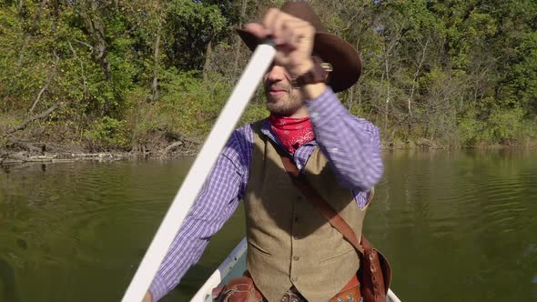Cowboy in a Canoe Floats on the River, Stock Footage | VideoHive