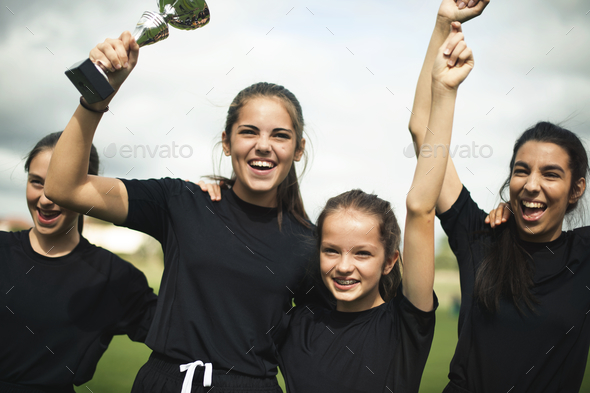 Young female football players celebrating their victory Stock Photo by ...
