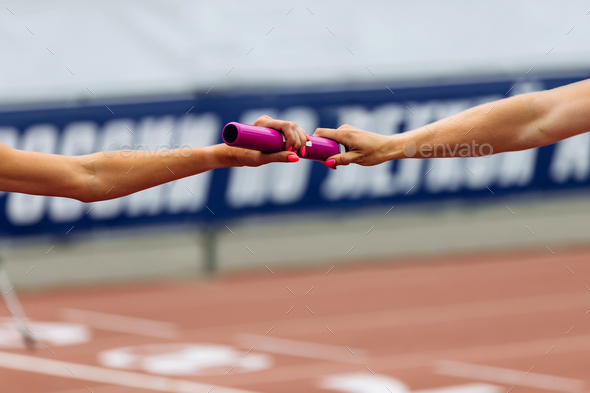 relay race racing hands women runners Stock Photo by realsportsphotos