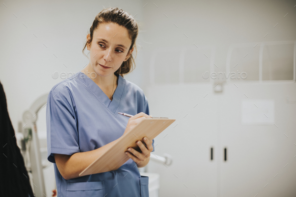 Young female nurse taking notes Stock Photo by Rawpixel | PhotoDune
