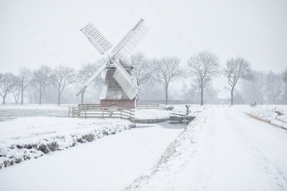 Dutch windmill in snowfall during winter Stock Photo by catolla | PhotoDune