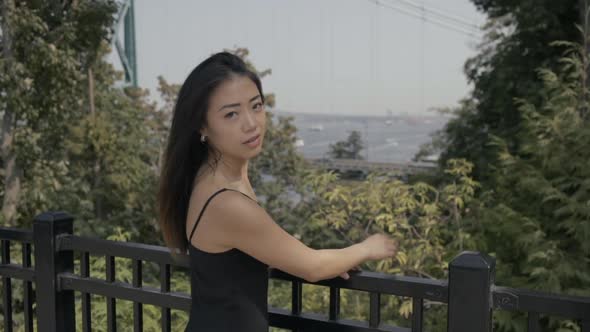 Medium shot of Beautiful Asian girl at Prospect point watching Lions gate bridge, Slowmo, Stock ...