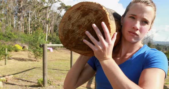Fit woman carrying heavy wooden log, Stock Footage | VideoHive