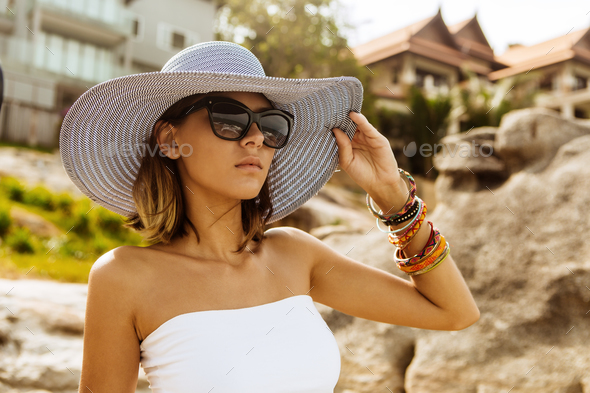 Pretty lady in summer outfit on the beach. Stock Photo by nikkolia