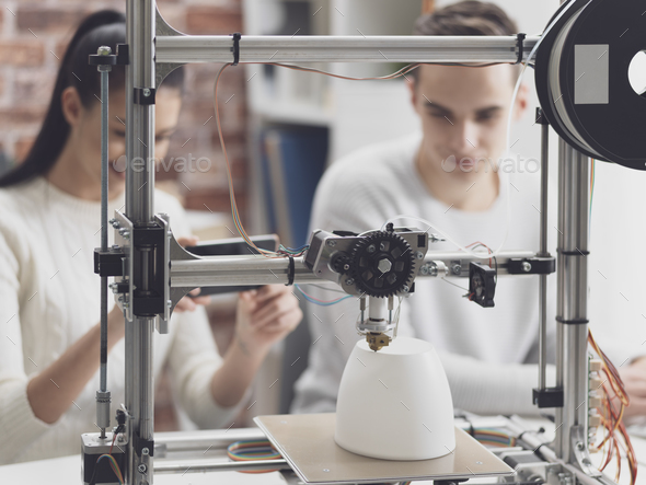 Academic students using a 3D printer in the lab Stock Photo by stokkete