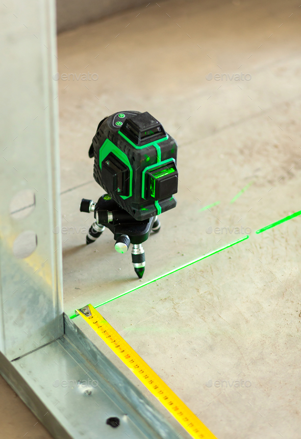 Laser level measuring tool in construction site. Stock Photo by ...