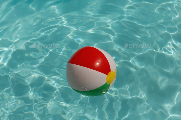 Inflatable ball floating in swimming pool on a sunny day Stock Photo by ...