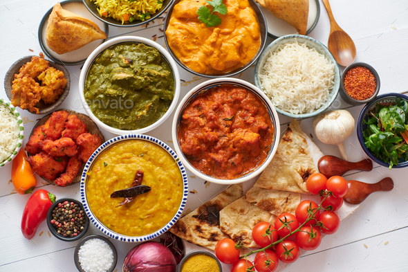 Assorted Indian various food with spices, rice and fresh vegetables ...