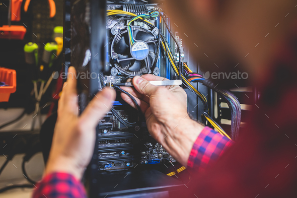 Man fixing PC in professional workshop. Stock Photo by photocreo ...