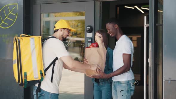 Smart Food Delivery Service Man Delivers Fresh Food to Recipient and ...