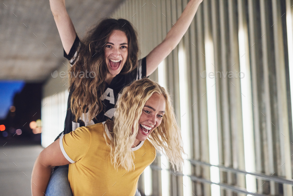 Young women having a fun night out in the city Stock Photo by ...