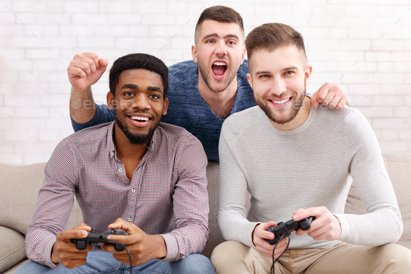 Gamers. Excited men playing video game at home Stock Photo by Prostock ...