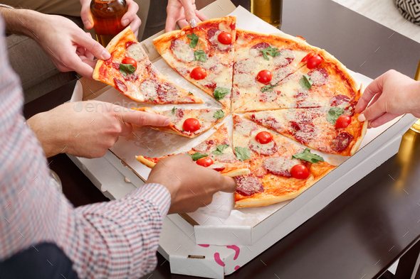 Lunch time. Friends eating delicious pizza, closeup Stock Photo by ...