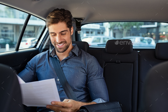 Businessman reading documents in car Stock Photo by Rido81 | PhotoDune