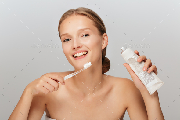 Portrait of young joyful lady without makeup holding toothpaste Stock ...