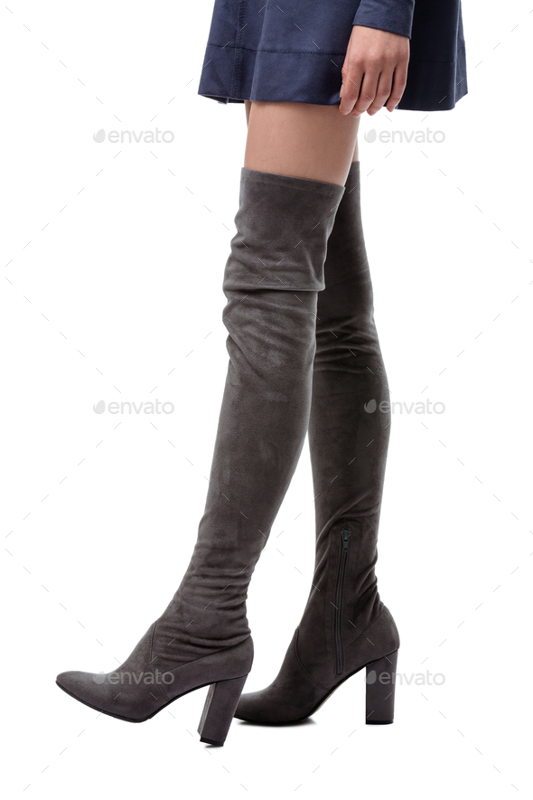 Close up photo of long woman legs in gray boots with heels on white ...