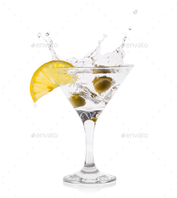 Martini splash with olives in a transparent glass Stock Photo by Alexlukin