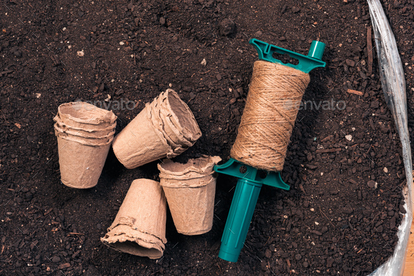 Biodegradable plant pots, jute rope and soil Stock Photo by stevanovicigor
