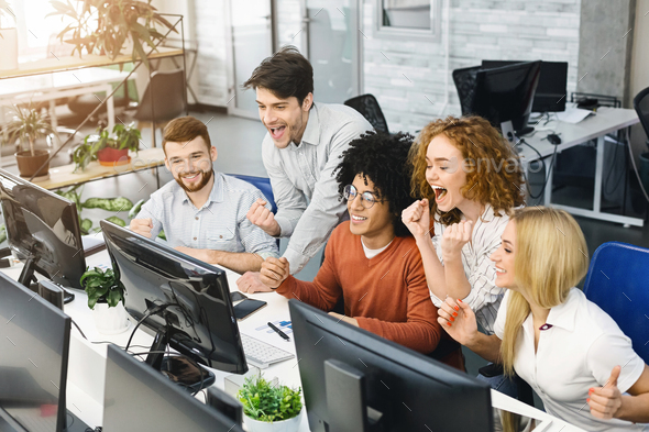 Cheerful emotional team reading winning results on monitor Stock Photo ...