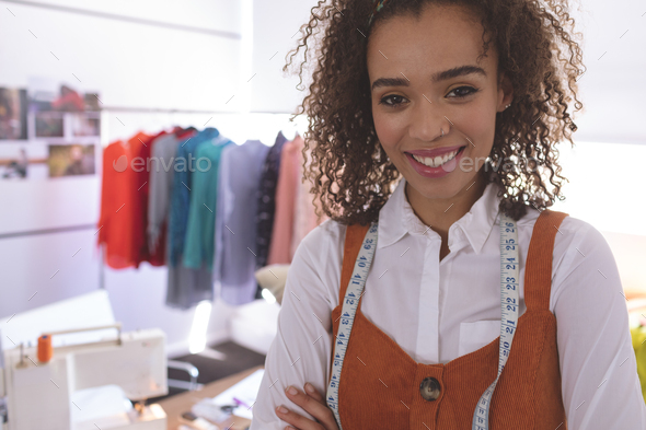Female fashion designer standing at table in design studio. Stock Photo ...