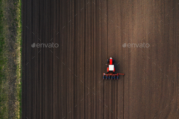 Top view of tractor planting corn seed in field Stock Photo by ...