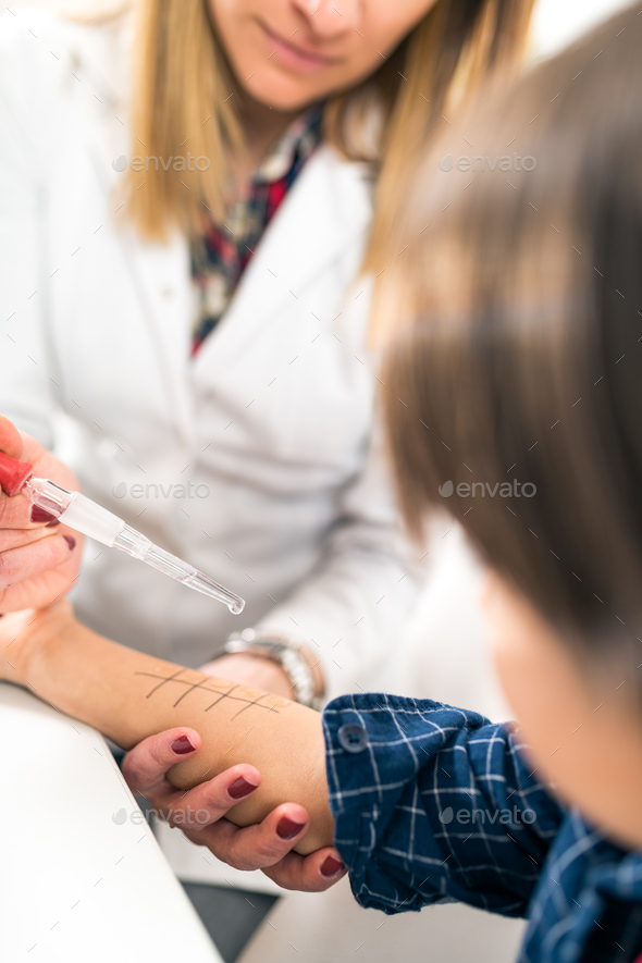 Doctor Doing Skin Allergy Test on a Little Boy Stock Photo by microgen