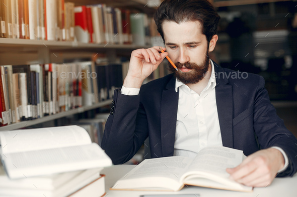 Handsome guy study at the library Stock Photo by prostooleh | PhotoDune