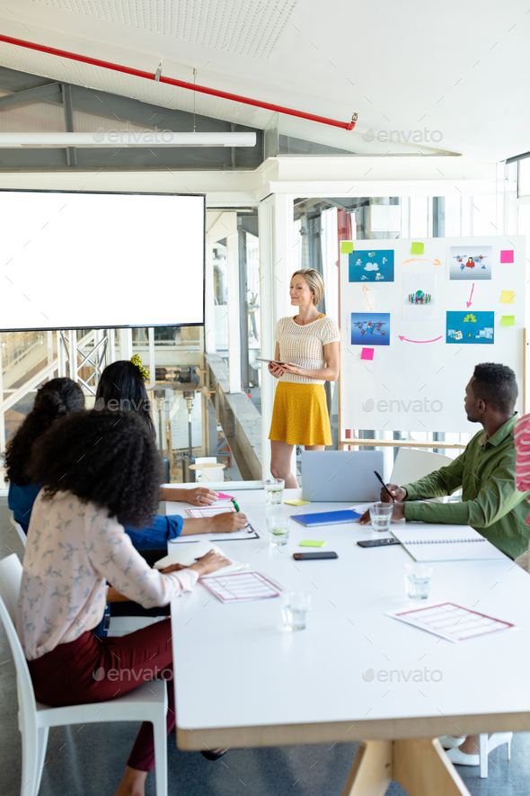 Front view of diverse businesswoman giving presentation on screen ...