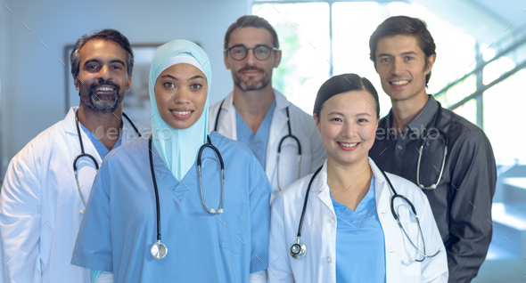Portrait of happy diverse medical team of doctors looking at camera in ...
