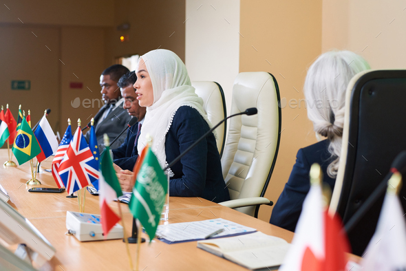 Confident young muslim female speaker talking in microphone Stock Photo ...