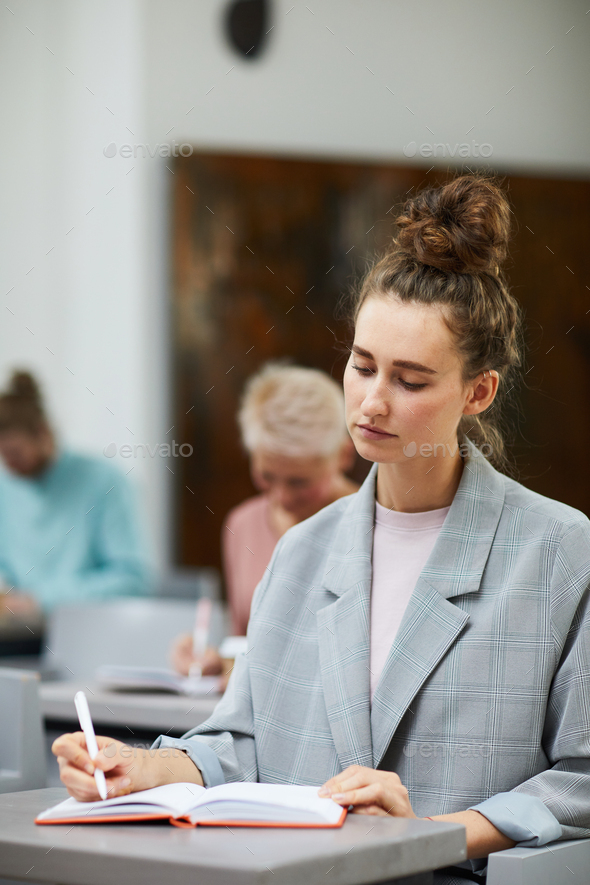 Contemporary Young Woman in Class Stock Photo by seventyfourimages