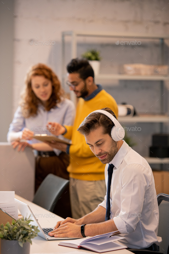 Adding information into presentation on laptop Stock Photo by Pressmaster