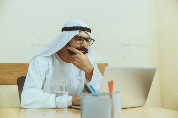 Arabian saudi businessman working in office Stock Photo by master1305