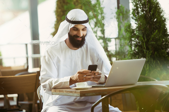 Arabian saudi businessman working outdoors Stock Photo by master1305