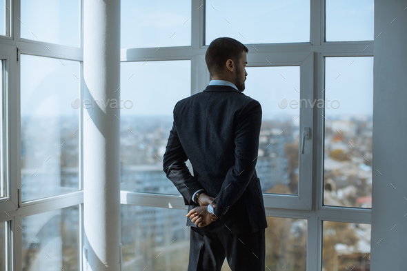 A Man in Suite at the Window Stock Photo by artfotodima | PhotoDune