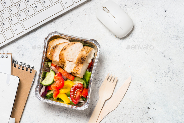 Food delivery concept - lunch box on office table Stock Photo by Nadianb