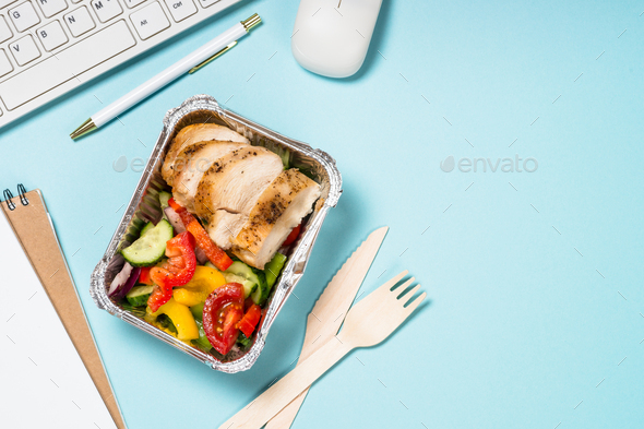 Food delivery concept - lunch box on office table Stock Photo by Nadianb