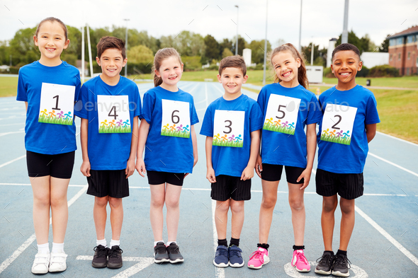 Portrait Of Children On Athletics Track Wearing Competitor Numbers On ...