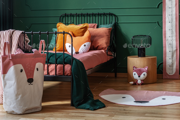 Fox theme in cute bedroom interior with green wall and orange bedding ...