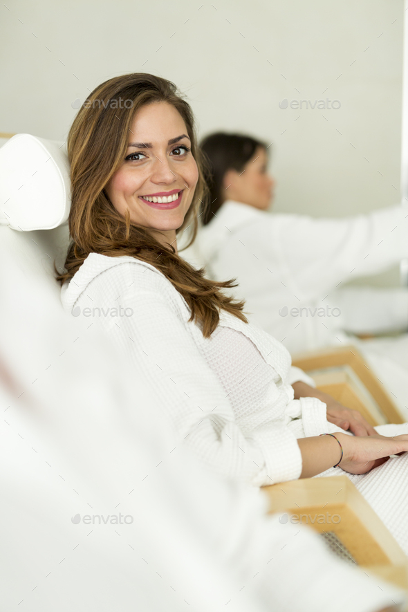 Portrait of a beautiful young woman relaxing in a robe Stock Photo by ...