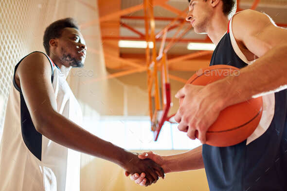 Serious basketball players from different team shaking hands Stock ...