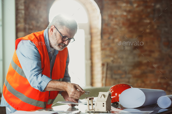Close up of male architect-engineer making a model of house Stock Photo ...