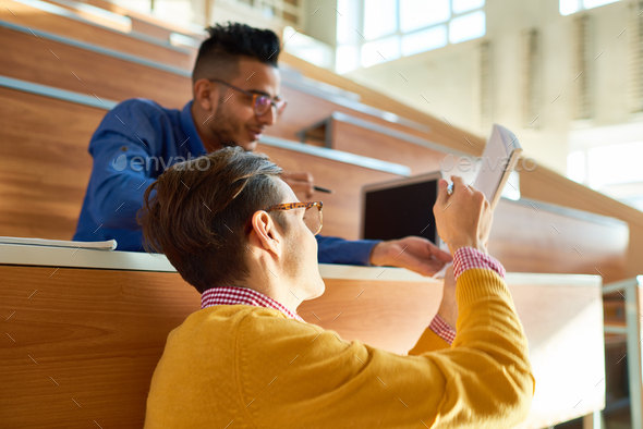 Students Helping Each Other Stock Photo by seventyfourimages | PhotoDune