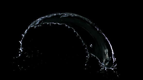Slow-motion splash water against black drop shooting with high speed ...