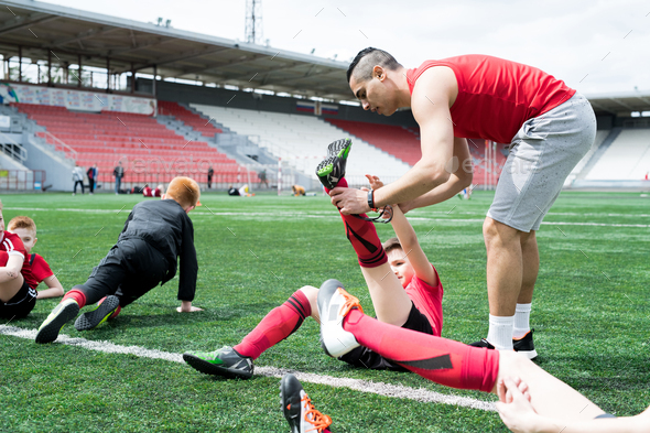 Junior Football Team Stretching at Practice Stock Photo by ...