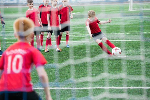 Boy Scoring Goal Stock Photo by seventyfourimages | PhotoDune